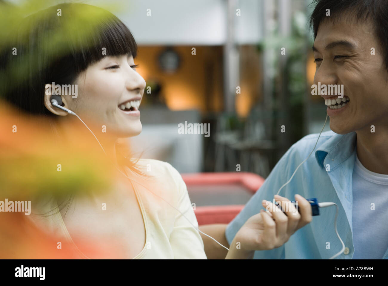 Couple sharing earbuds hi-res stock photography and images - Alamy