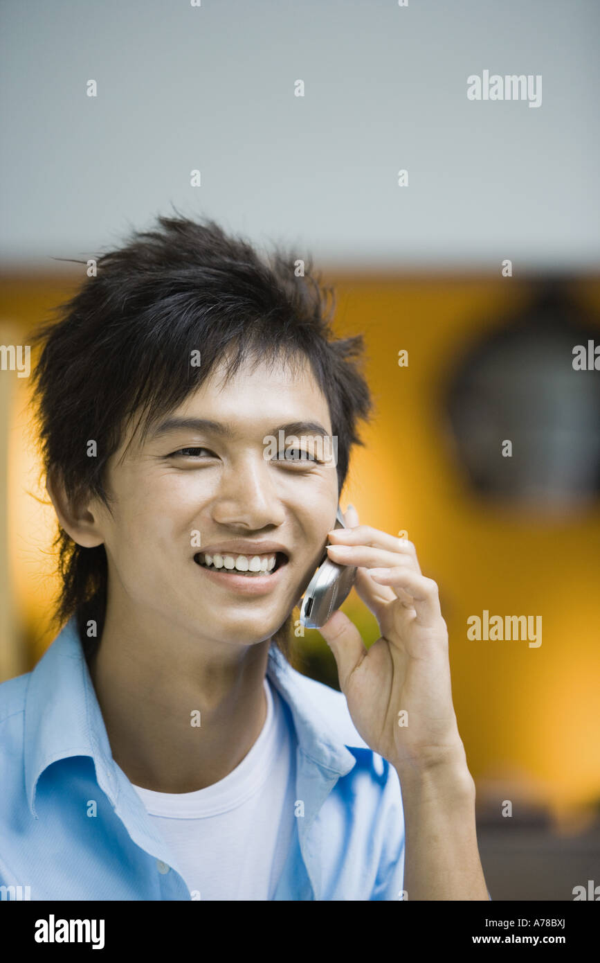 Young man using cell phone Stock Photo - Alamy