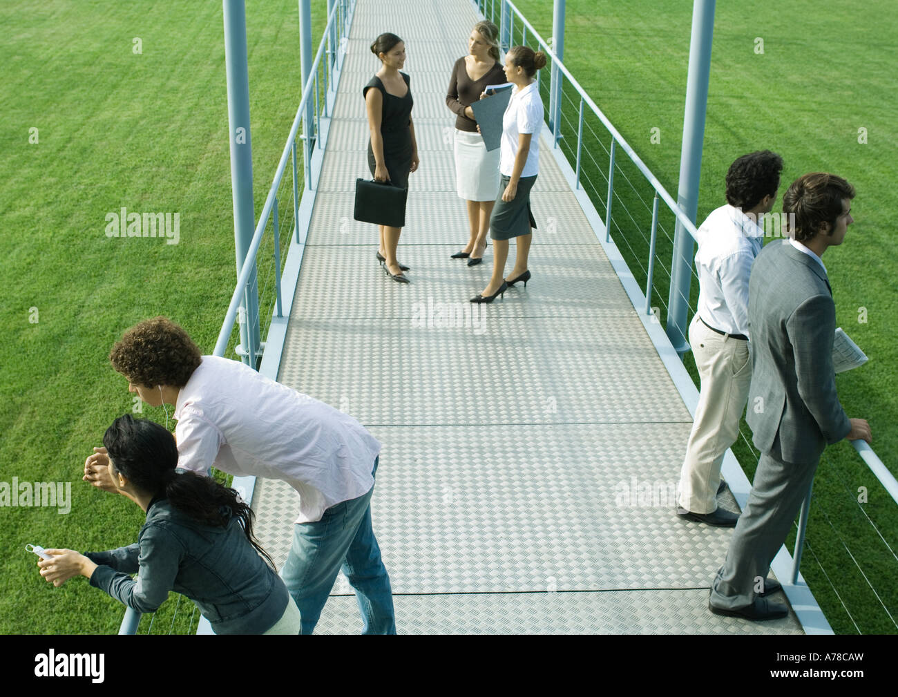 People standing in small groups on walkway, high angle view Stock Photo ...