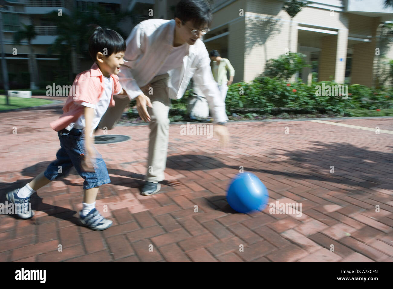 Father and son playing ball, blurred motion Stock Photo - Alamy