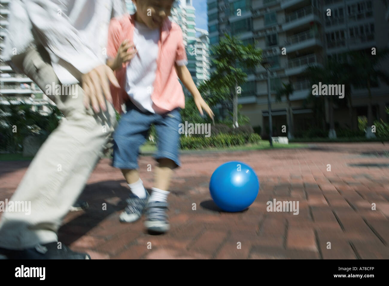 Father and son playing ball, blurred motion Stock Photo - Alamy