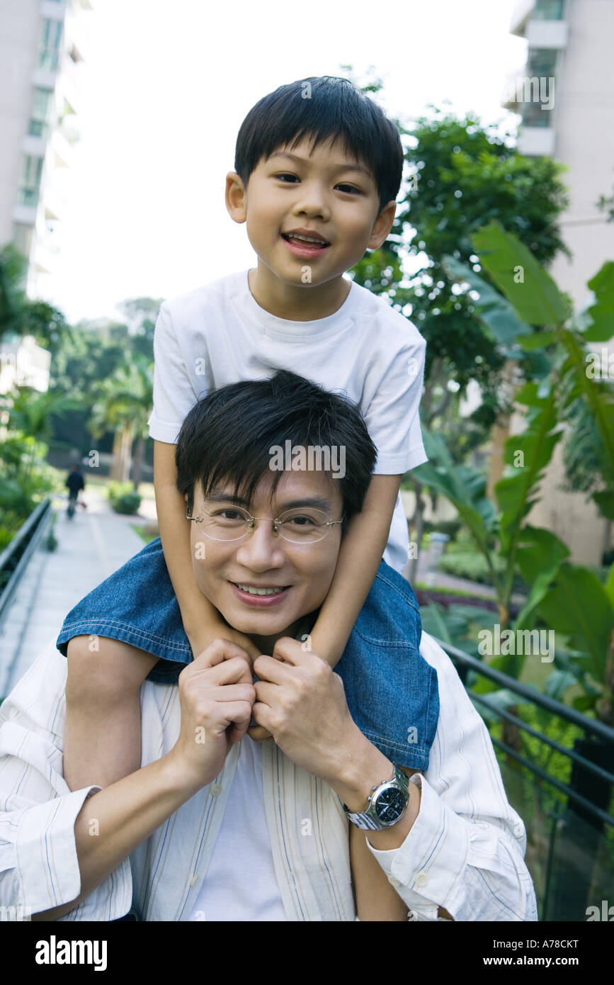 Kid son riding dads shoulders hi-res stock photography and images - Alamy