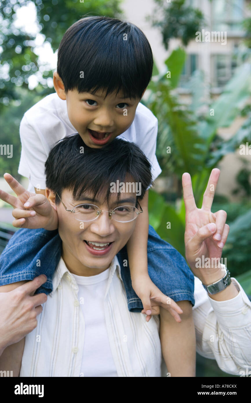 Kid son riding dads shoulders hi-res stock photography and images - Alamy