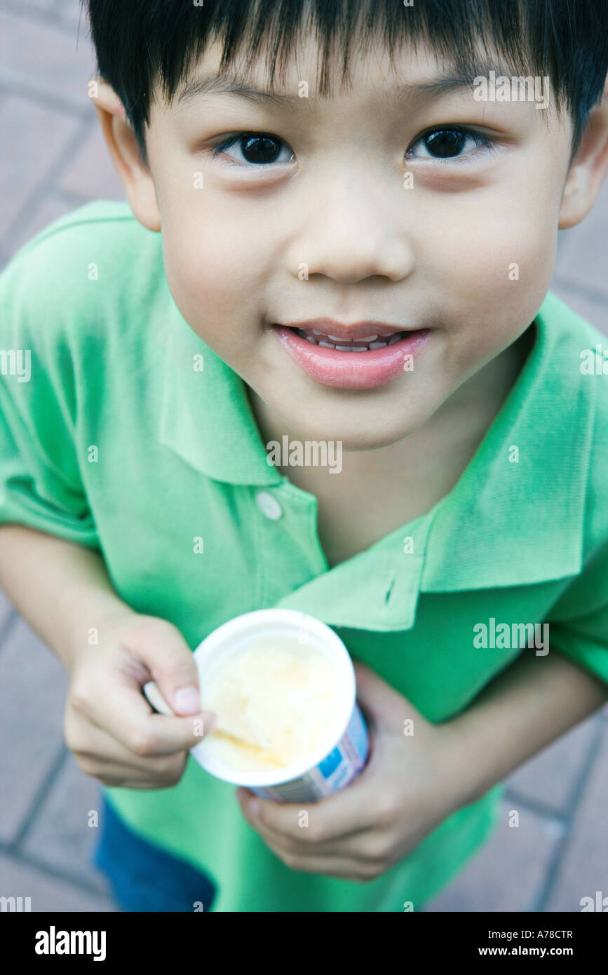 Boy holding sweet snack, smiling at camera Stock Photo - Alamy