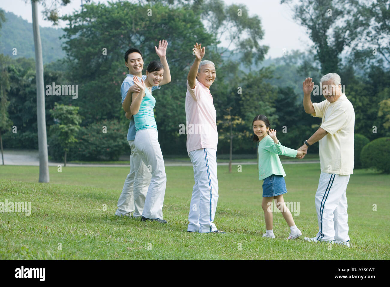 Three generation family waving at camera Stock Photo - Alamy