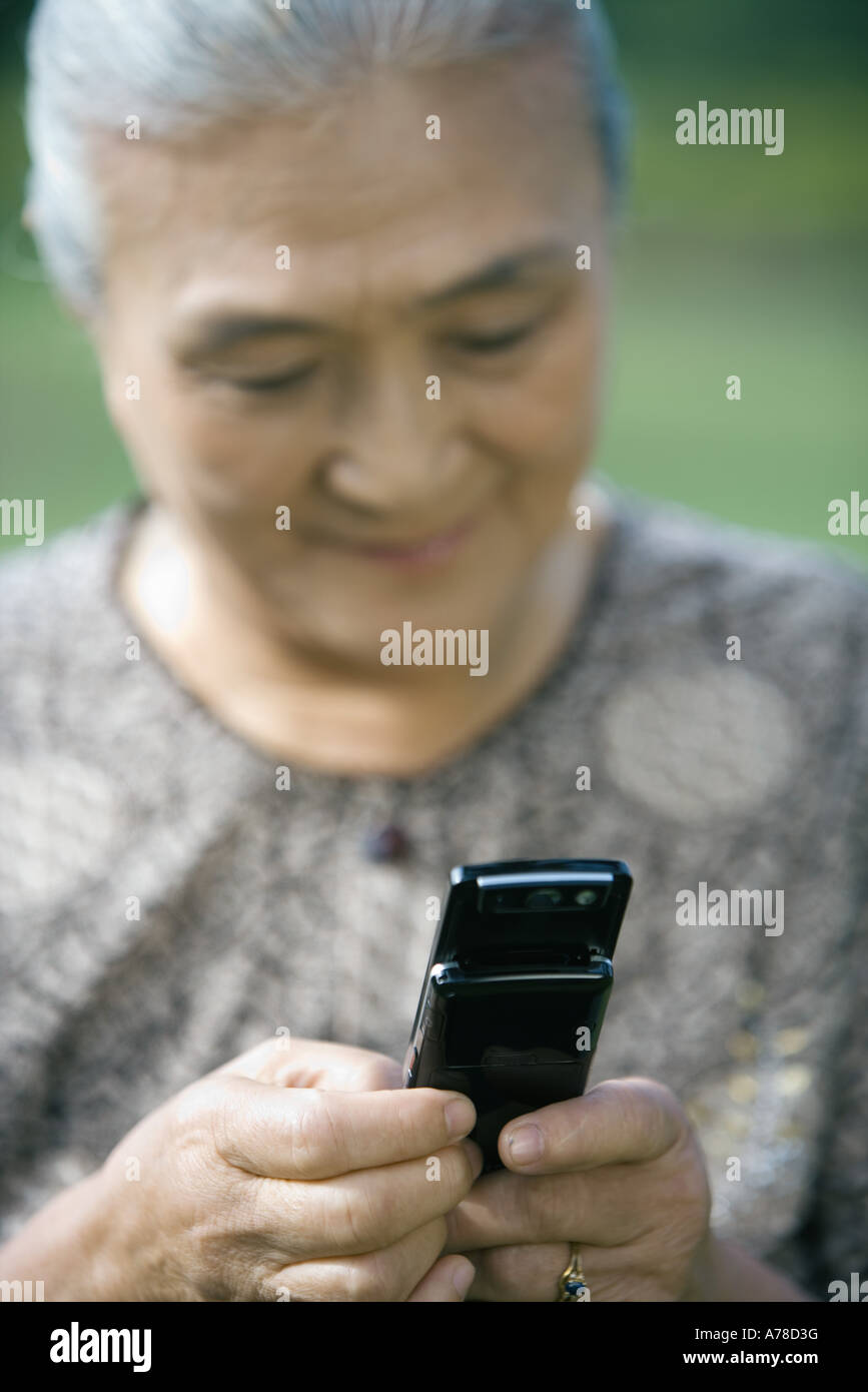 Senior woman dialing cell phone Stock Photo - Alamy