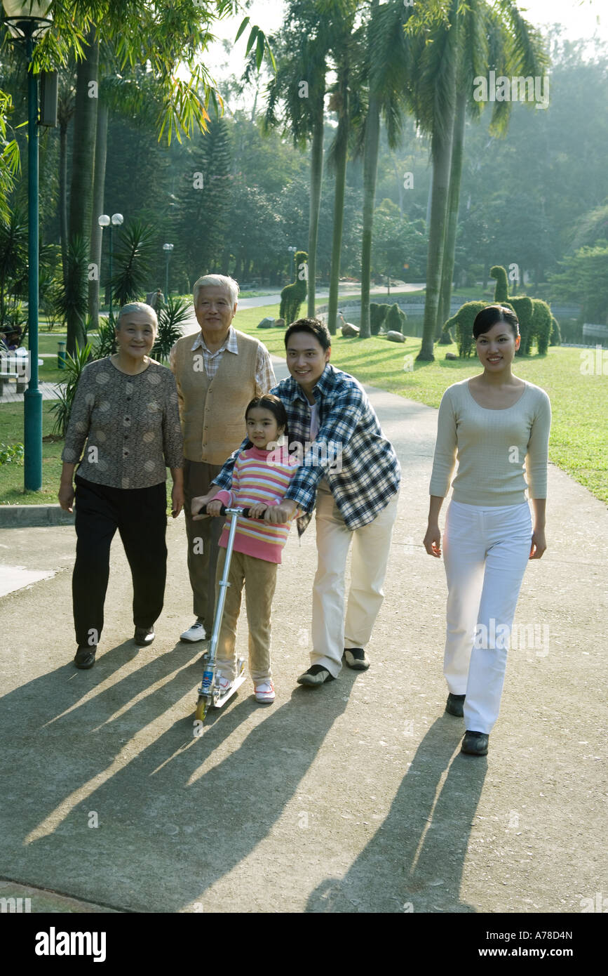 Three generation family walking in park Stock Photo - Alamy