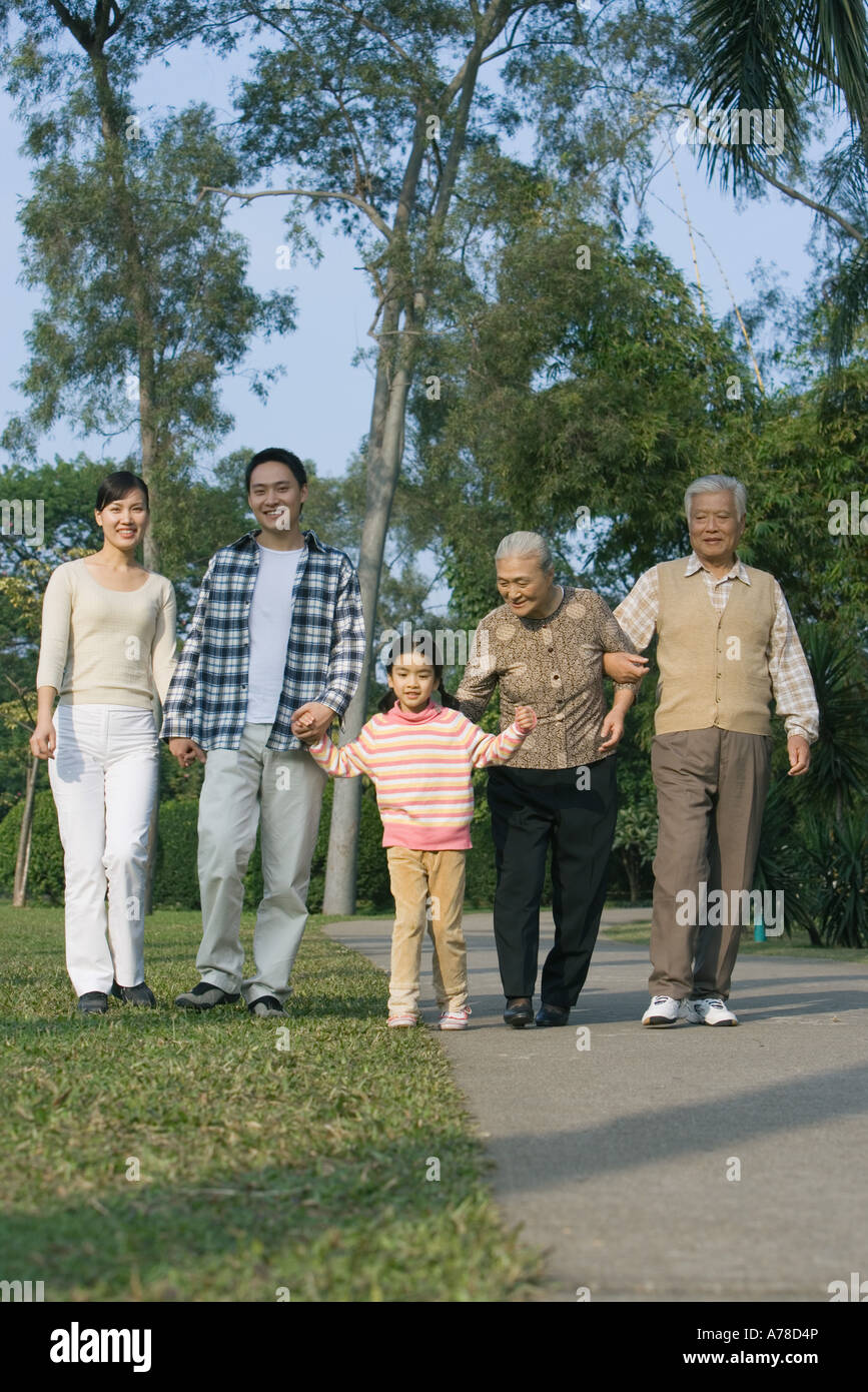 Three generation family walking in park Stock Photo - Alamy
