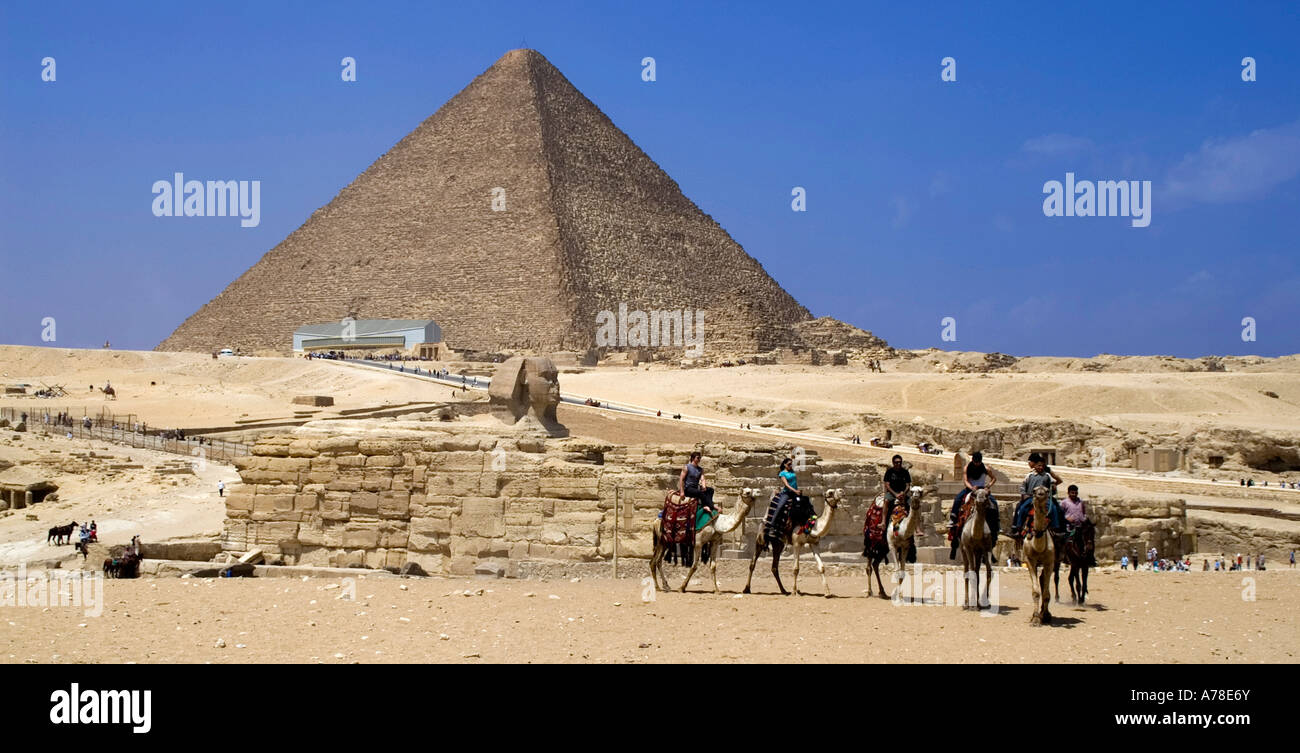 Tourists on camels at the Pyramids Giza Cairo Stock Photo - Alamy
