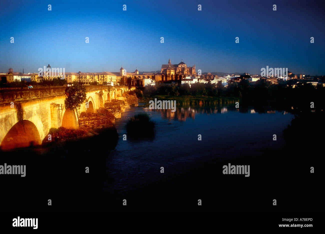 The Puente Romano Bridge over the River Guadalquivir at sunrise looking ...