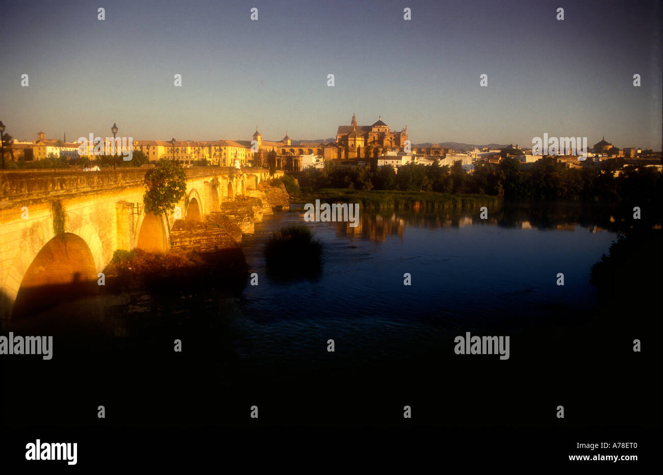 The Puente Romano Bridge over the River Guadalquivir at sunrise looking ...