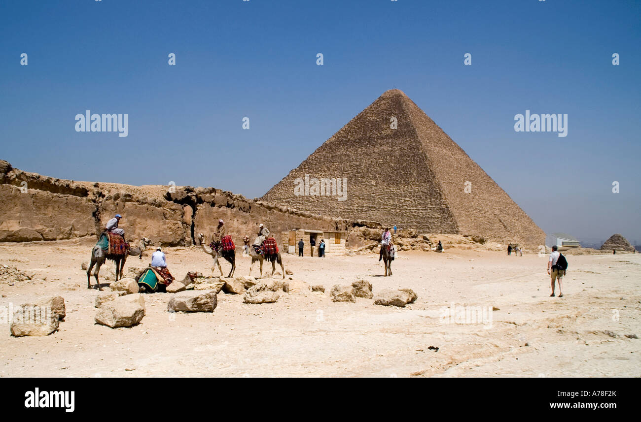 Tourists and locals on camels at the Pyramids Giza Cairo Stock Photo ...