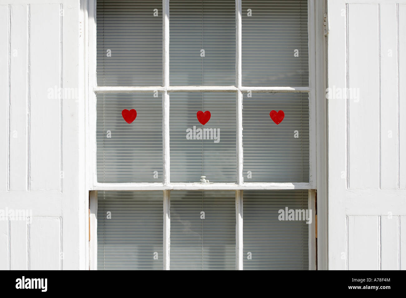three red heart shaped stickers on sash window Stock Photo - Alamy