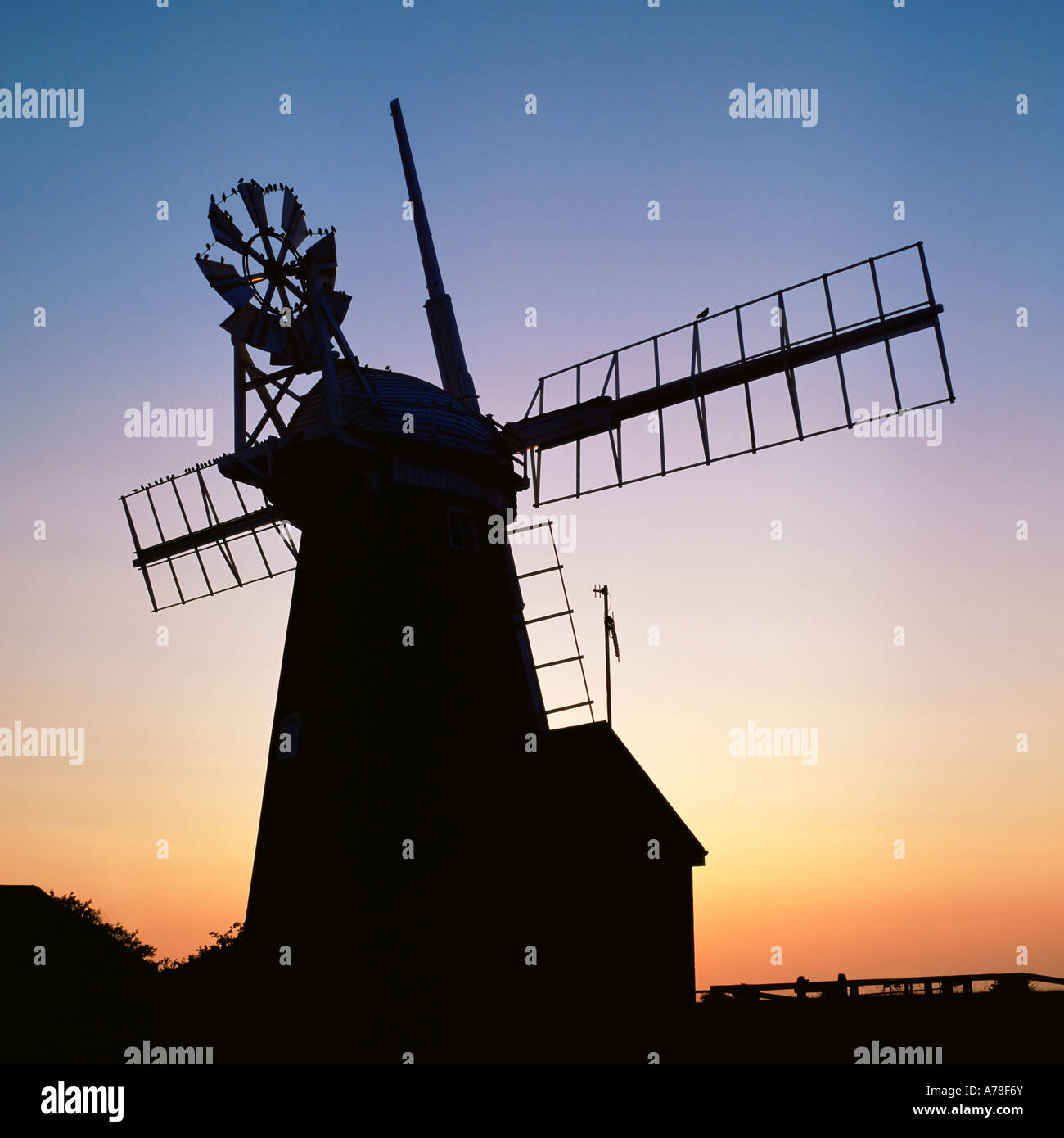 Silhouette of a windmill at sunset Stock Photo - Alamy