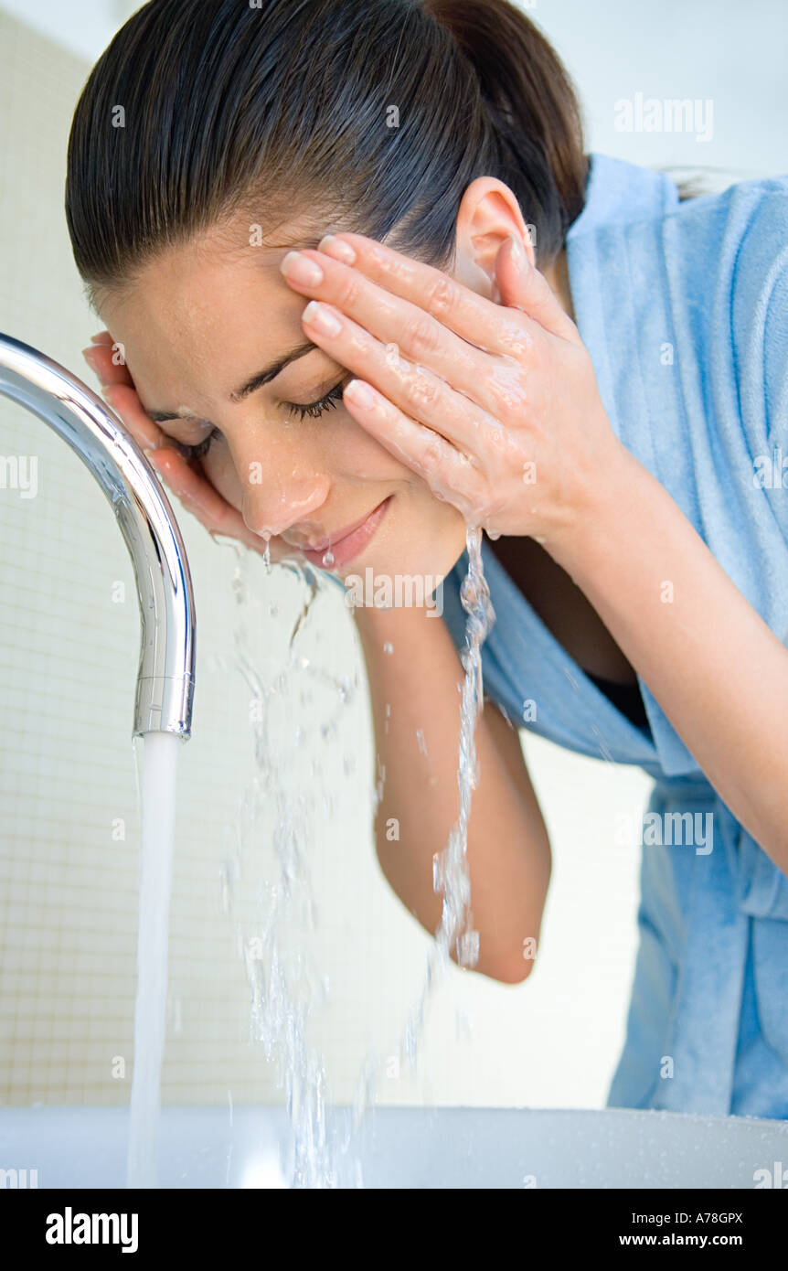 Woman washing face Stock Photo - Alamy