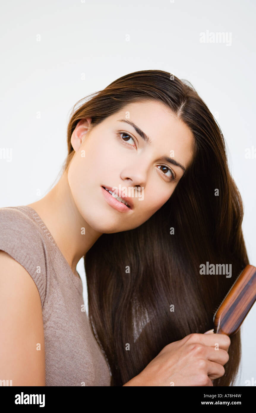 Woman brushing hair Stock Photo - Alamy