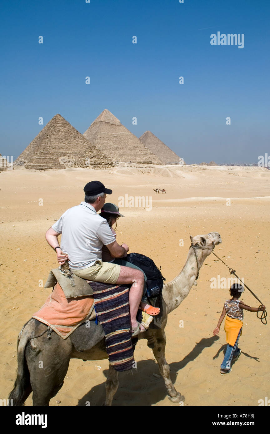 Tourists on camels at the Pyramids Giza Cairo Stock Photo - Alamy