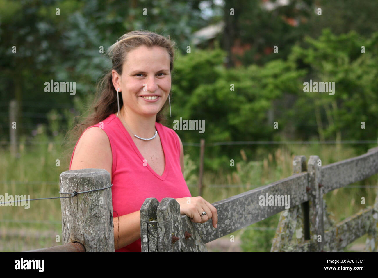 portrait of woman at a rural gate Stock Photo - Alamy