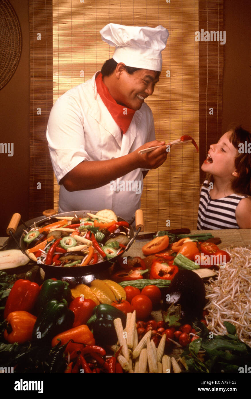 Chef offering food to a child Stock Photo - Alamy