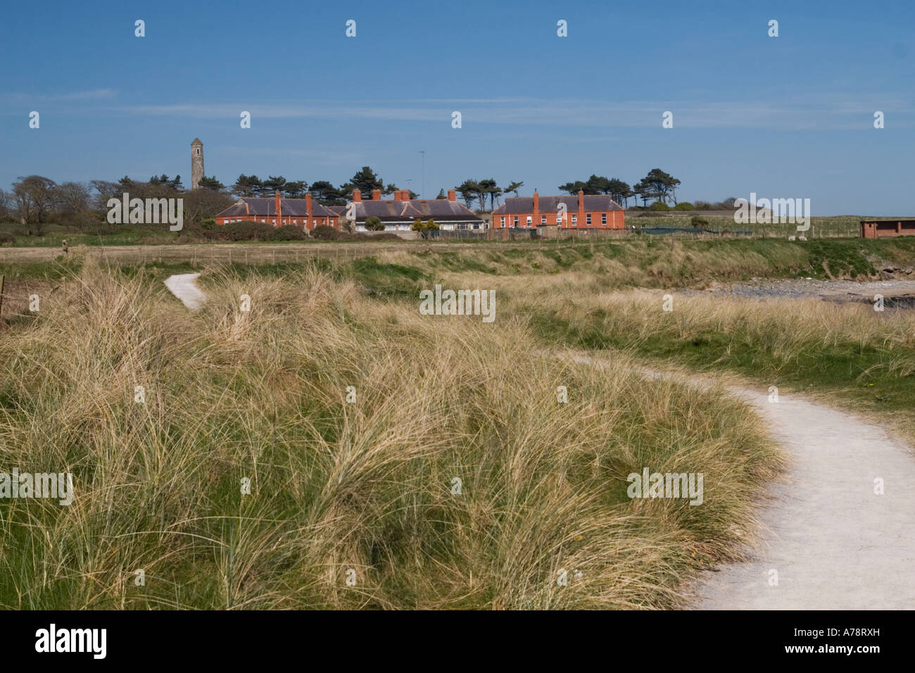 Winding sand path leading to hospital surrounded by grasses Stock Photo ...