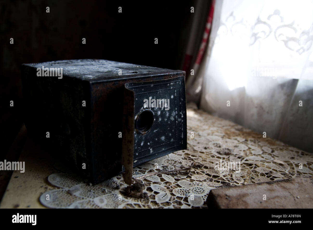 Old camera on a table with window and curtains in the background Stock ...