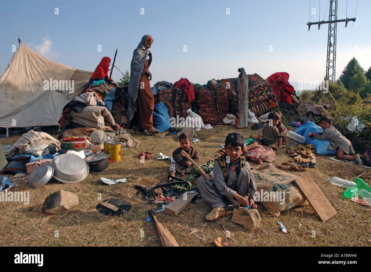 Nomadic Gypsies preparing clothes to trade in a village mountain above ...