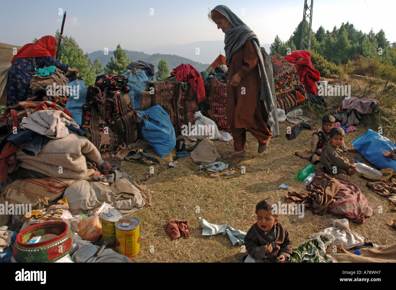 Nomadic Gypsies preparing clothes to trade in a village mountain above ...