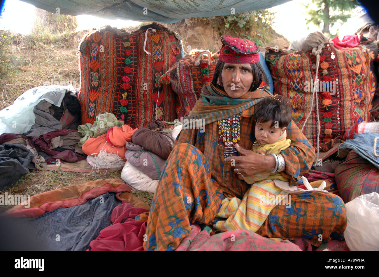 Nomadic Gypsies preparing clothes to trade in a village mountain above ...