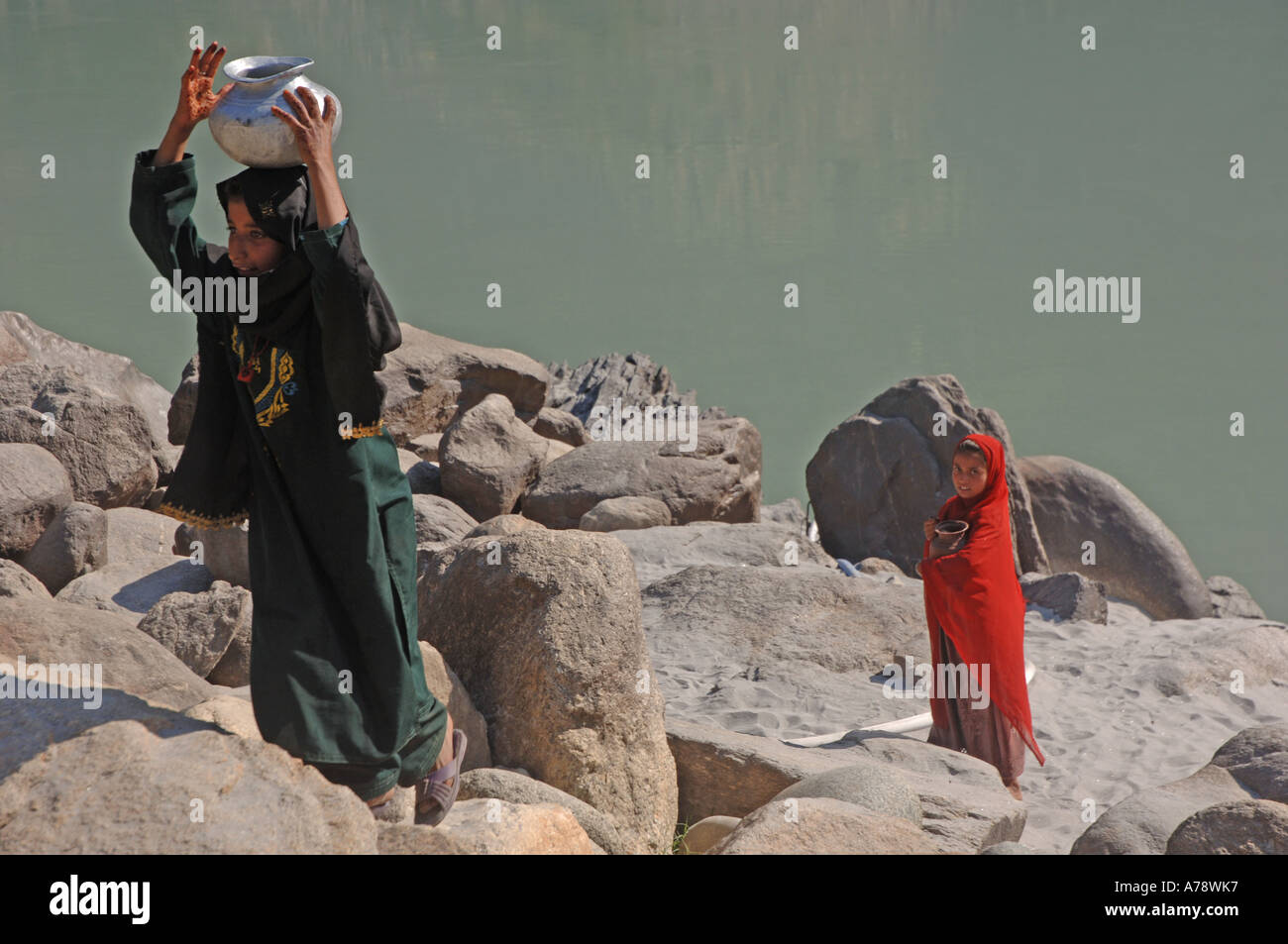 Women and children wash clothes in the river Indus, Allai valley ...