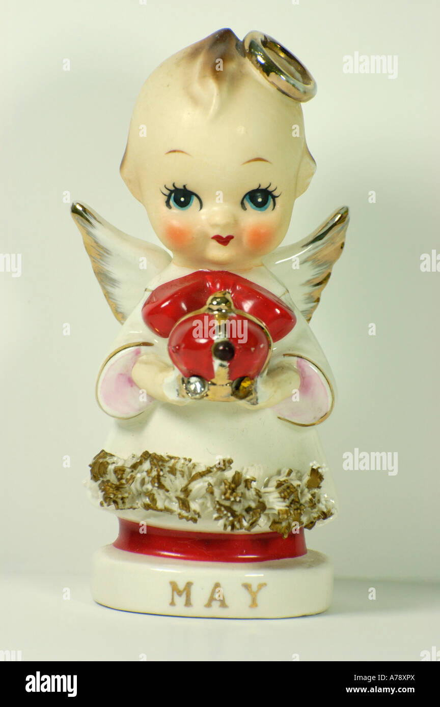 Stock image close up of a ceramic May angel figurine holding a jeweled ...