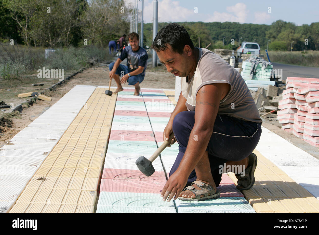 man work pavement working repair avenue way road Stock Photo - Alamy