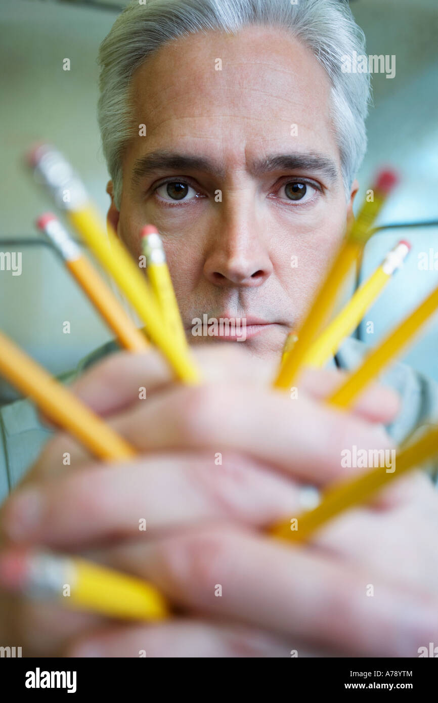 Man holding pencils Stock Photo - Alamy