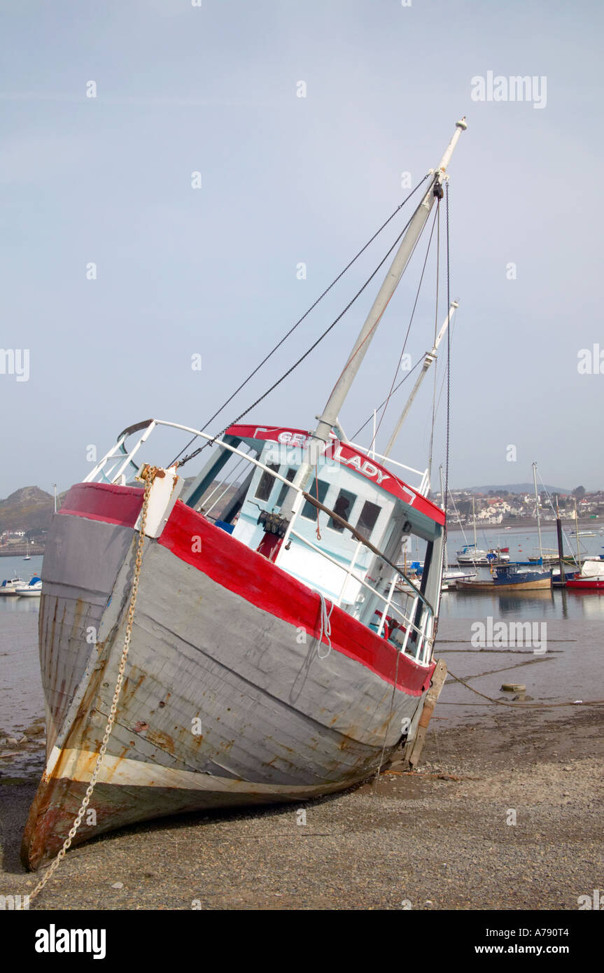 Abandoned decaying boat on the banks of the estuary in Conwy , North ...