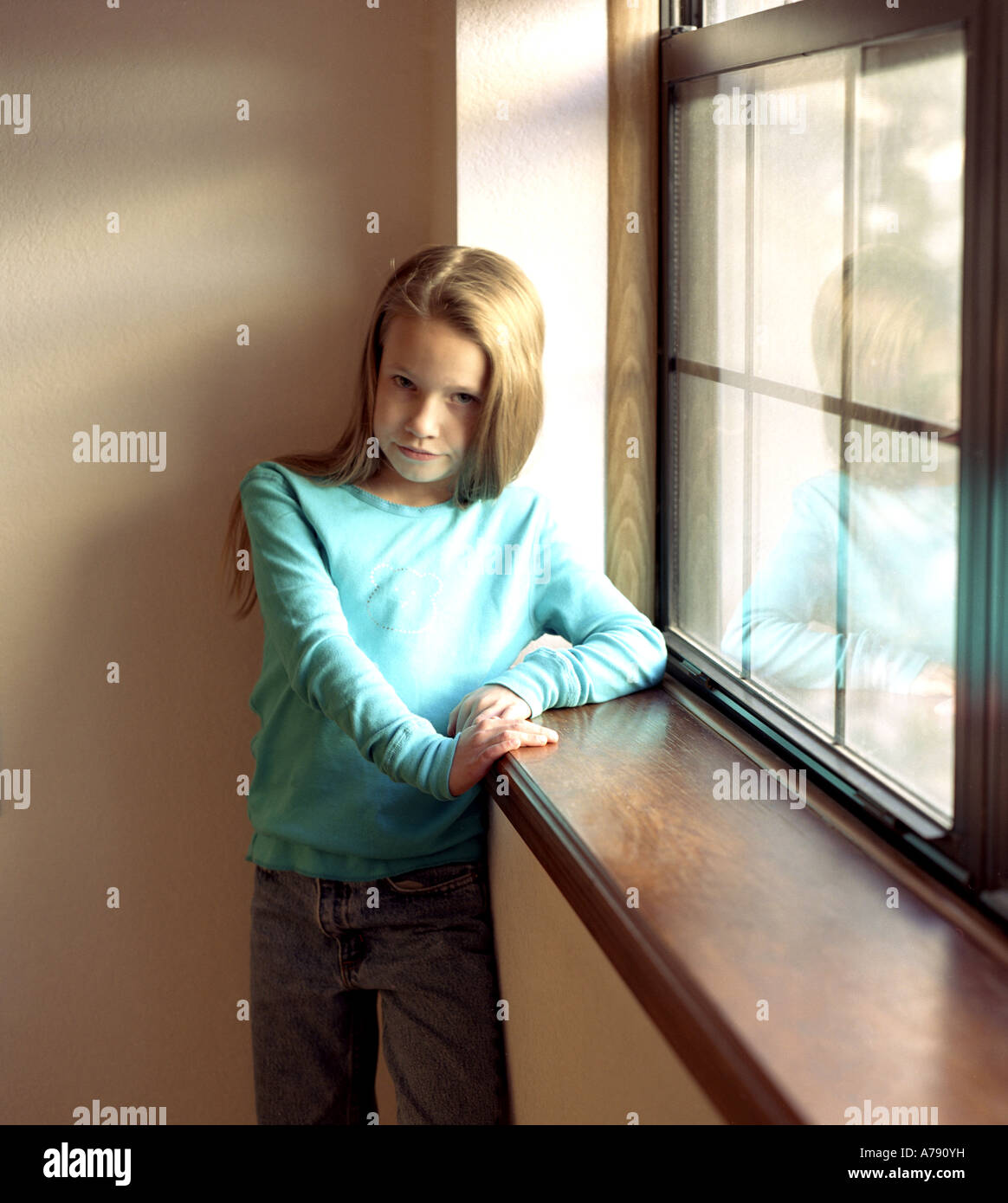 Young girl at a home window Stock Photo - Alamy