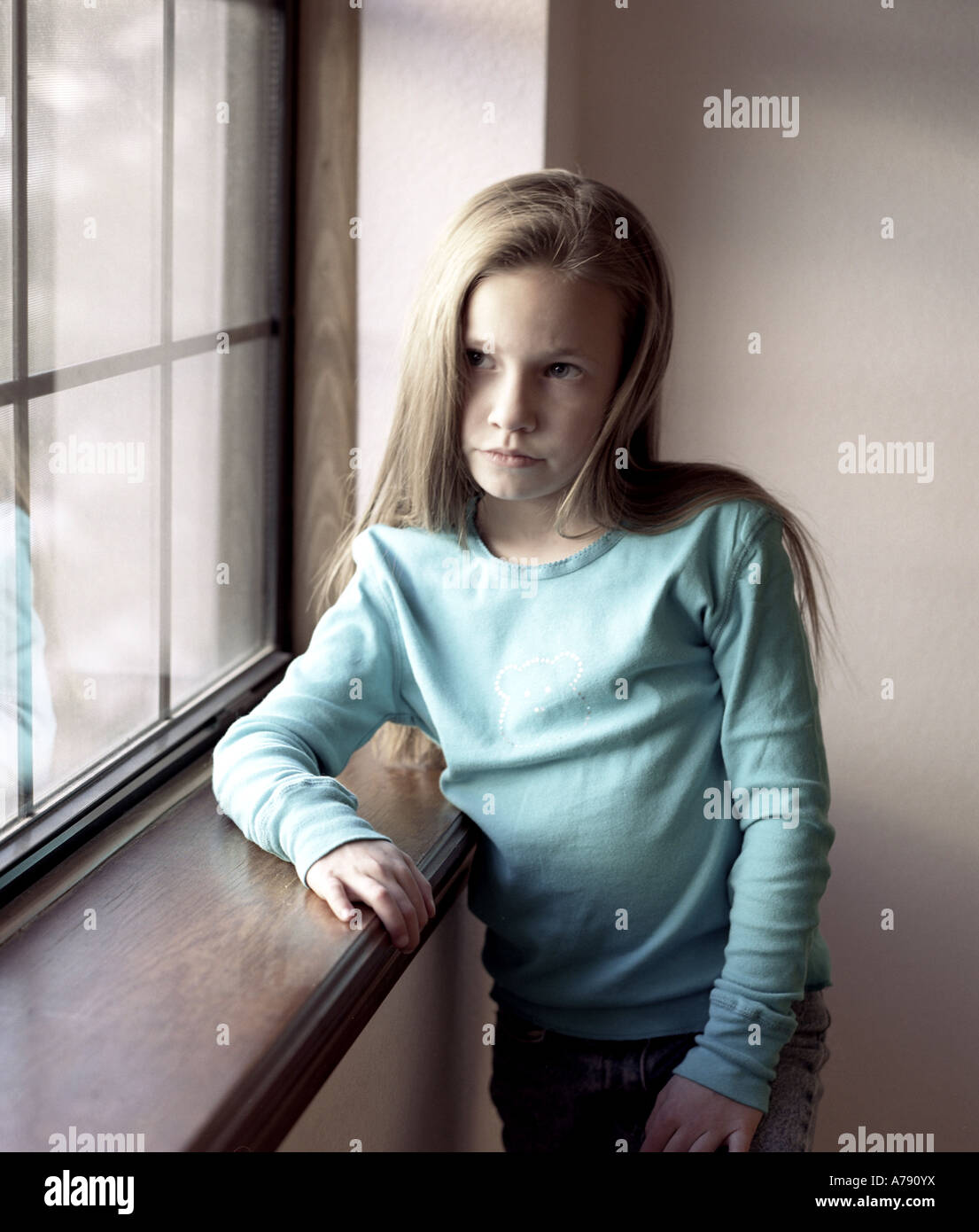 Young girl at a home window Stock Photo - Alamy