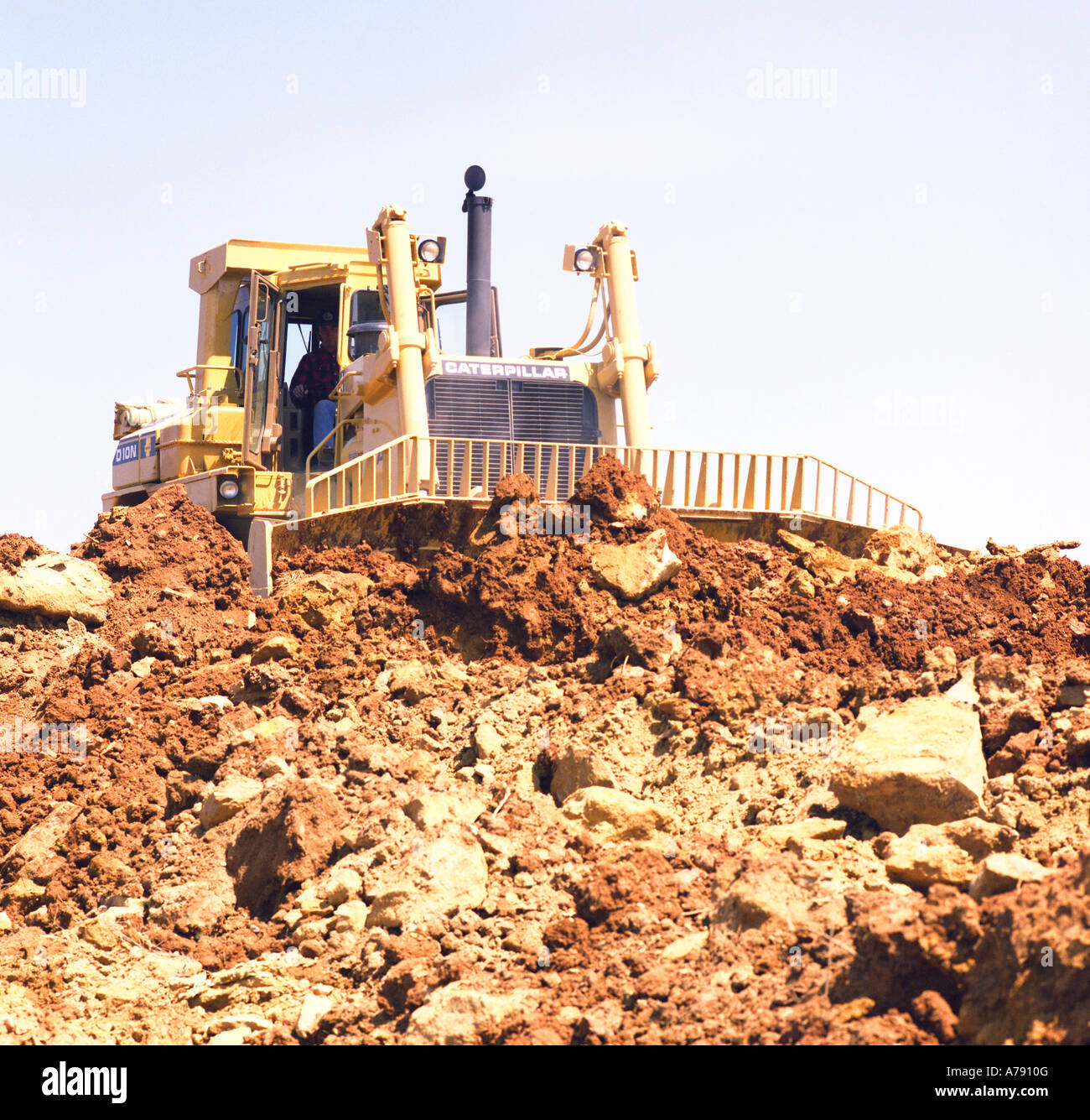 Caterpillar D10 bulldozer at a construction site clearing ground for a ...