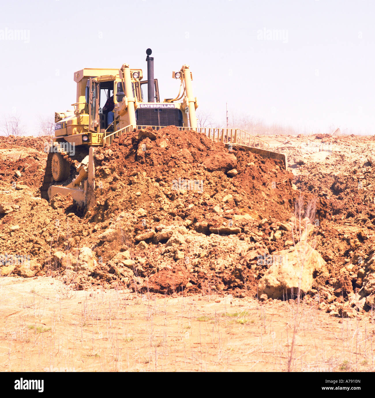 Caterpillar D10 bulldozer at a construction site clearing ground for a ...