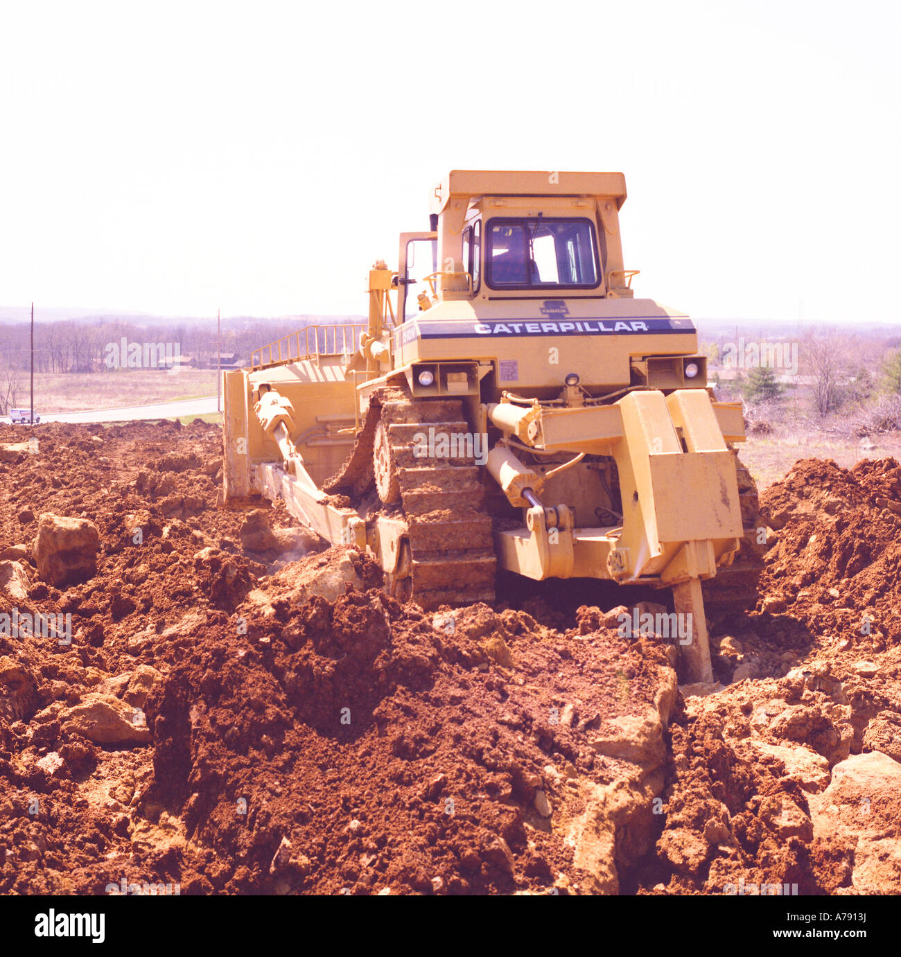 Caterpillar D10 bulldozer at a construction site clearing ground for a ...