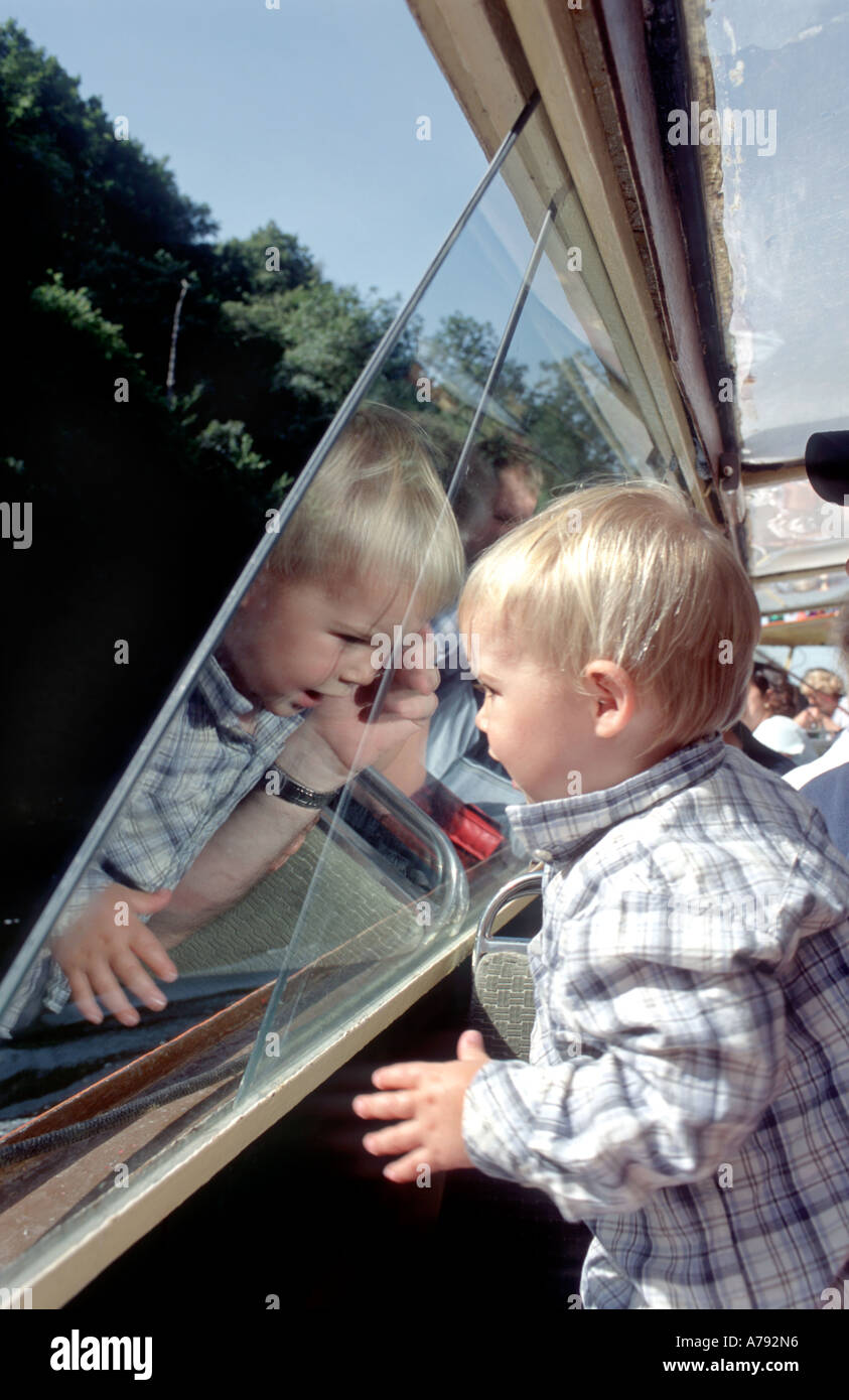 CHILD LOOKING WINDOW BOAT Wonderment Stock Photo - Alamy