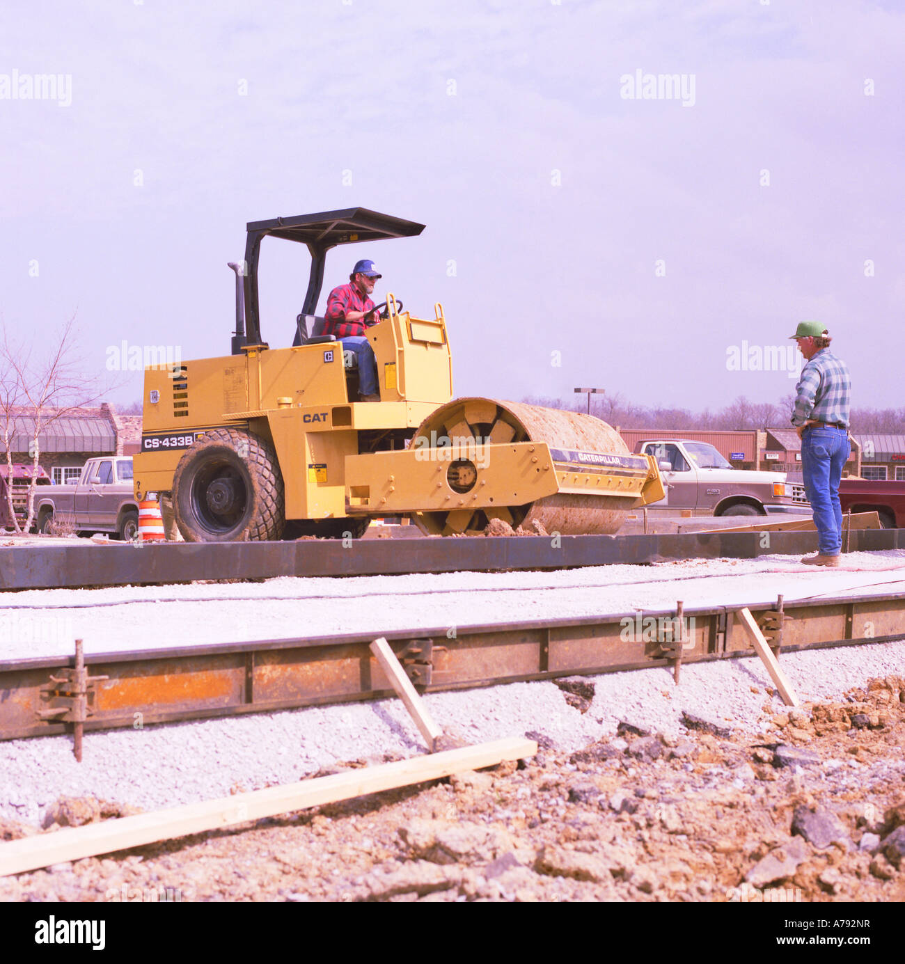 Roller or compactor at a construction site preparing the ground for ...