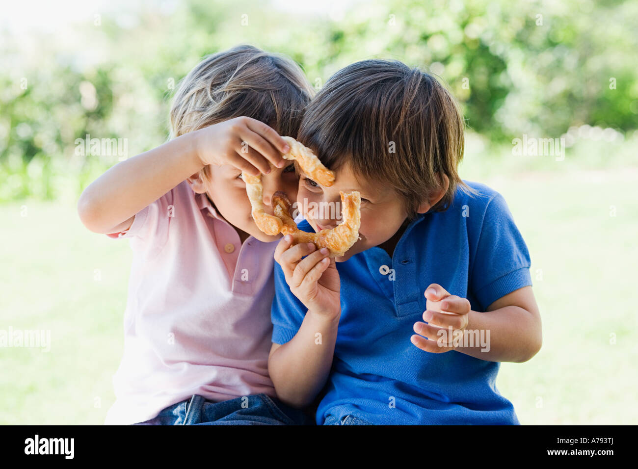 Two boys sharing a cake Stock Photo - Alamy