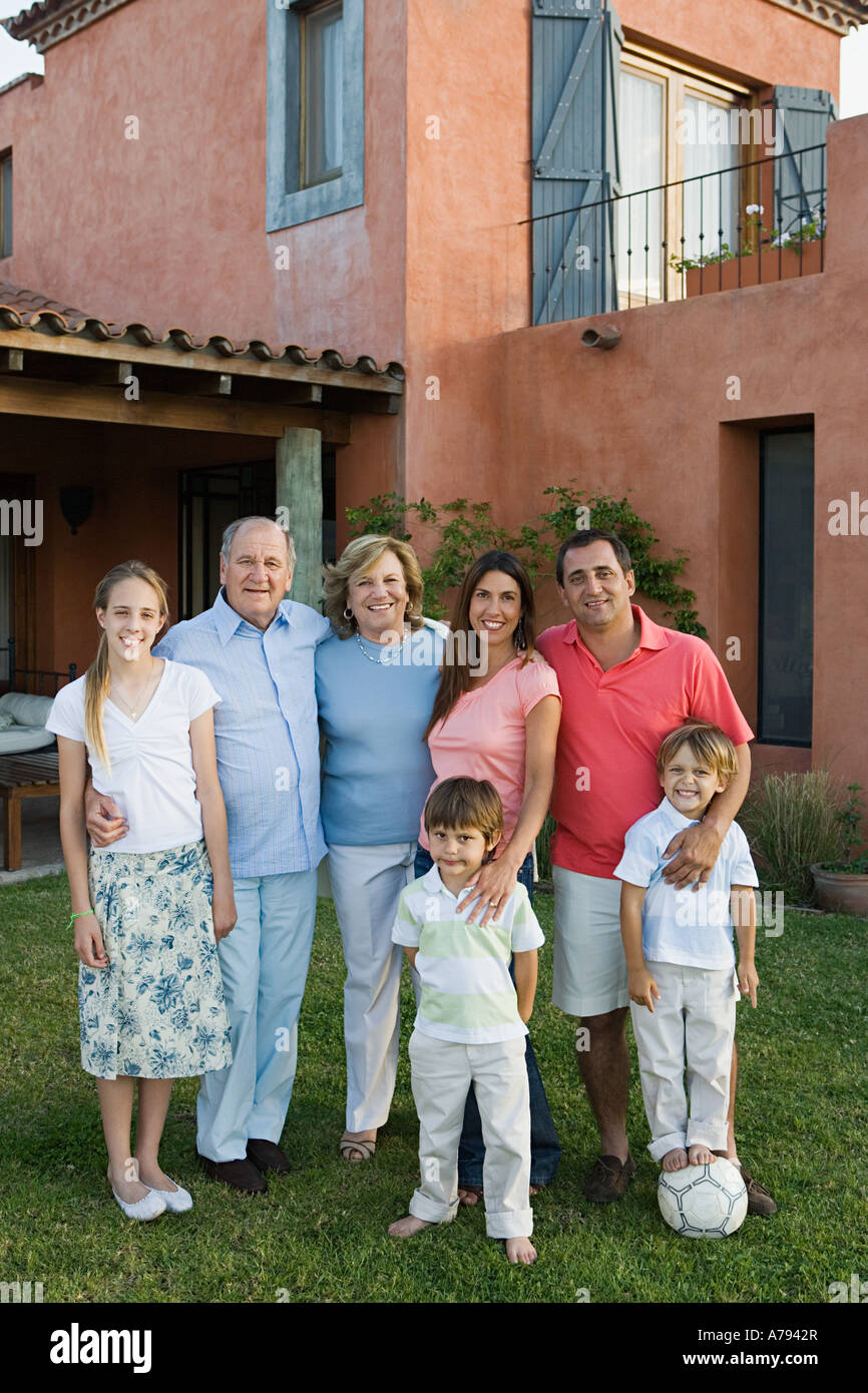 Family standing outside house Stock Photo - Alamy