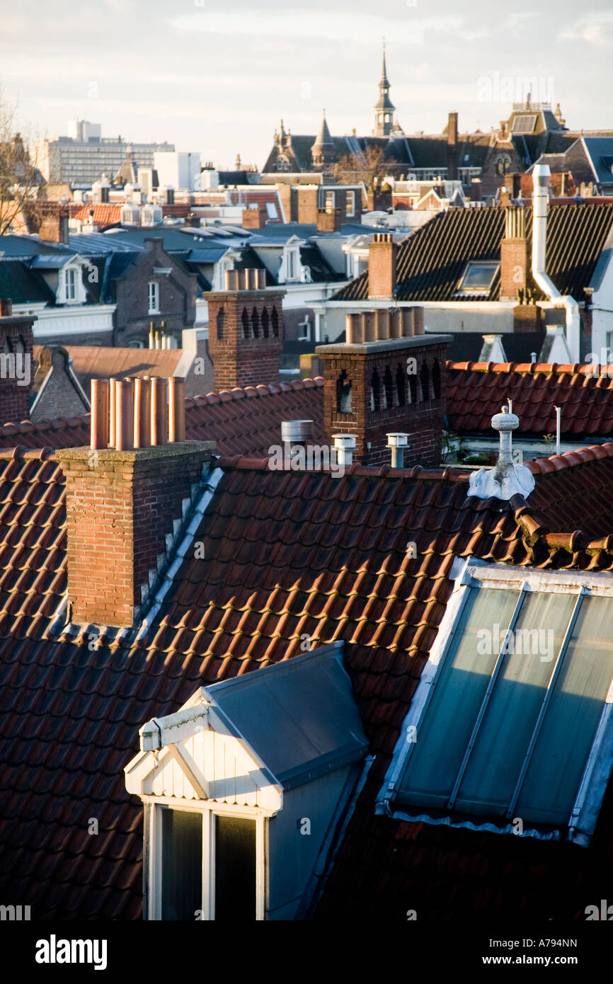 old roof in amsterdam tiles and chimneys Stock Photo - Alamy
