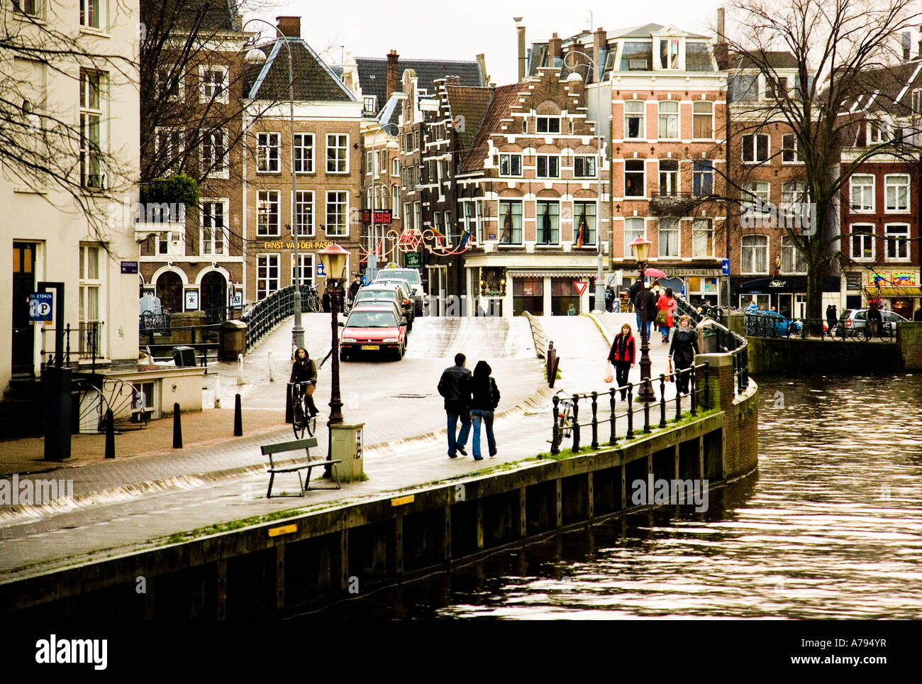 traditional amsterdam architecture with canal bridge boats and bicycle ...