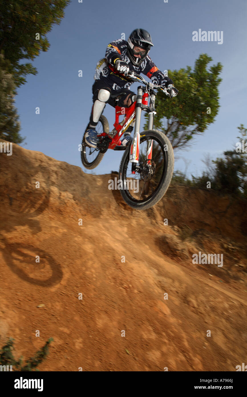 Downhill Mountain Bike Rider Comes over the Edge Stock Photo - Alamy
