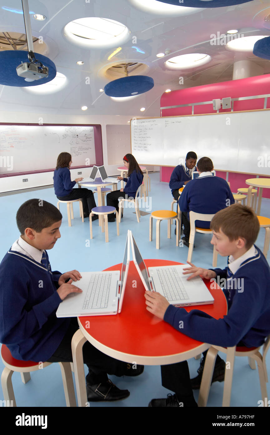 Schoolboy and schoolgirl children pupils in modern classroom of the ...