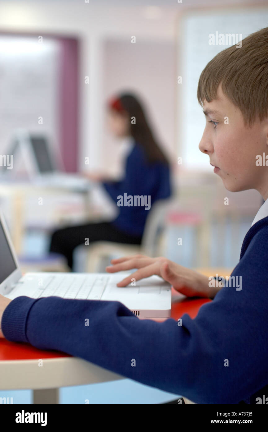 Schoolboy and schoolgirl children pupils in modern classroom of the ...