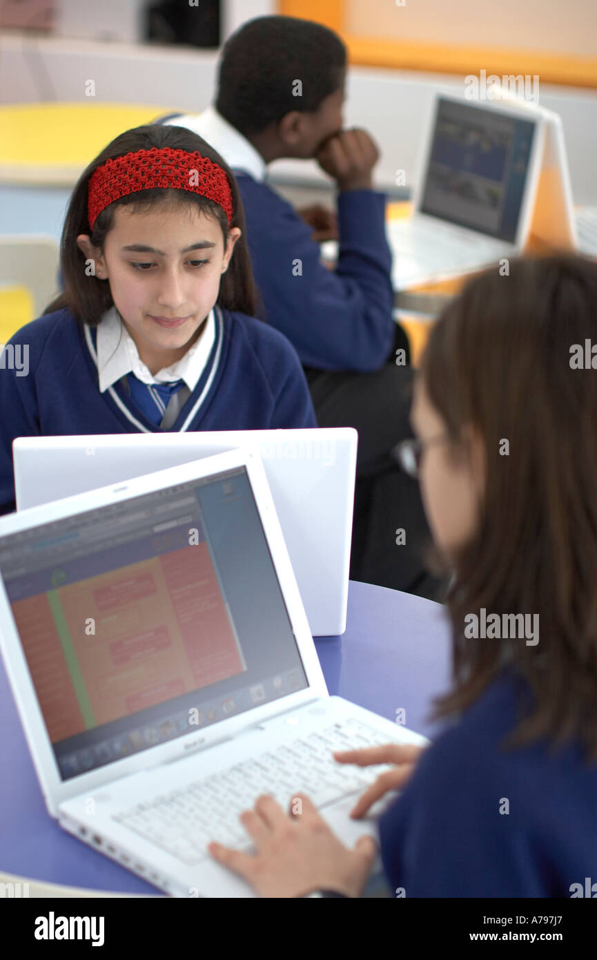 Schoolboy and schoolgirl children pupils in modern classroom of the ...