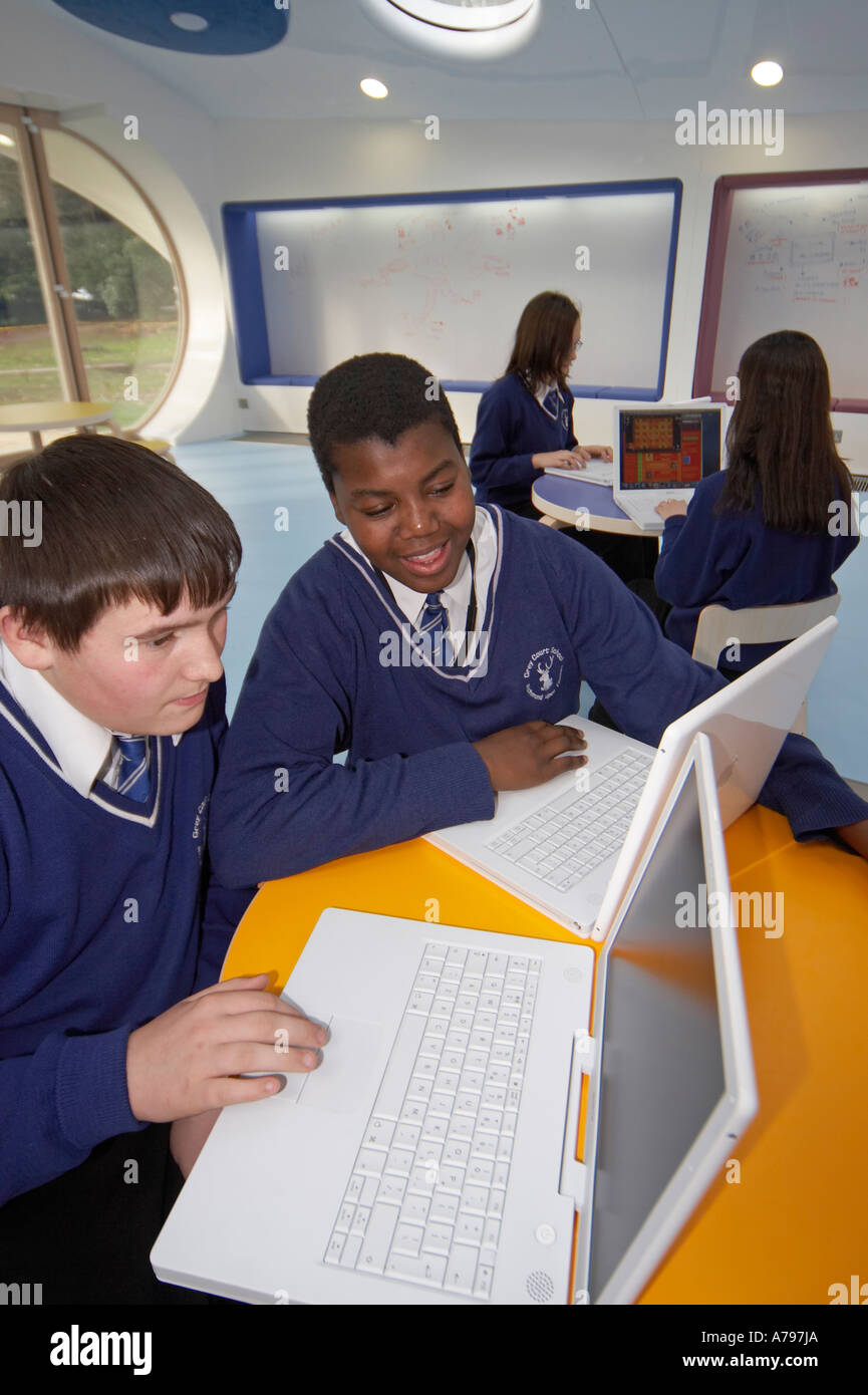 Schoolboy and schoolgirl children pupils in modern classroom of the ...