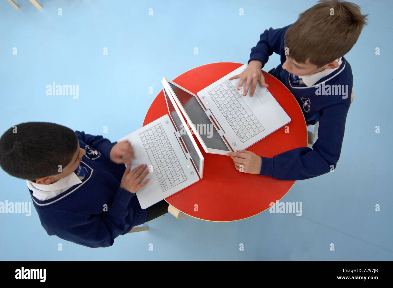 Schoolboy and schoolgirl children pupils in modern classroom of the ...